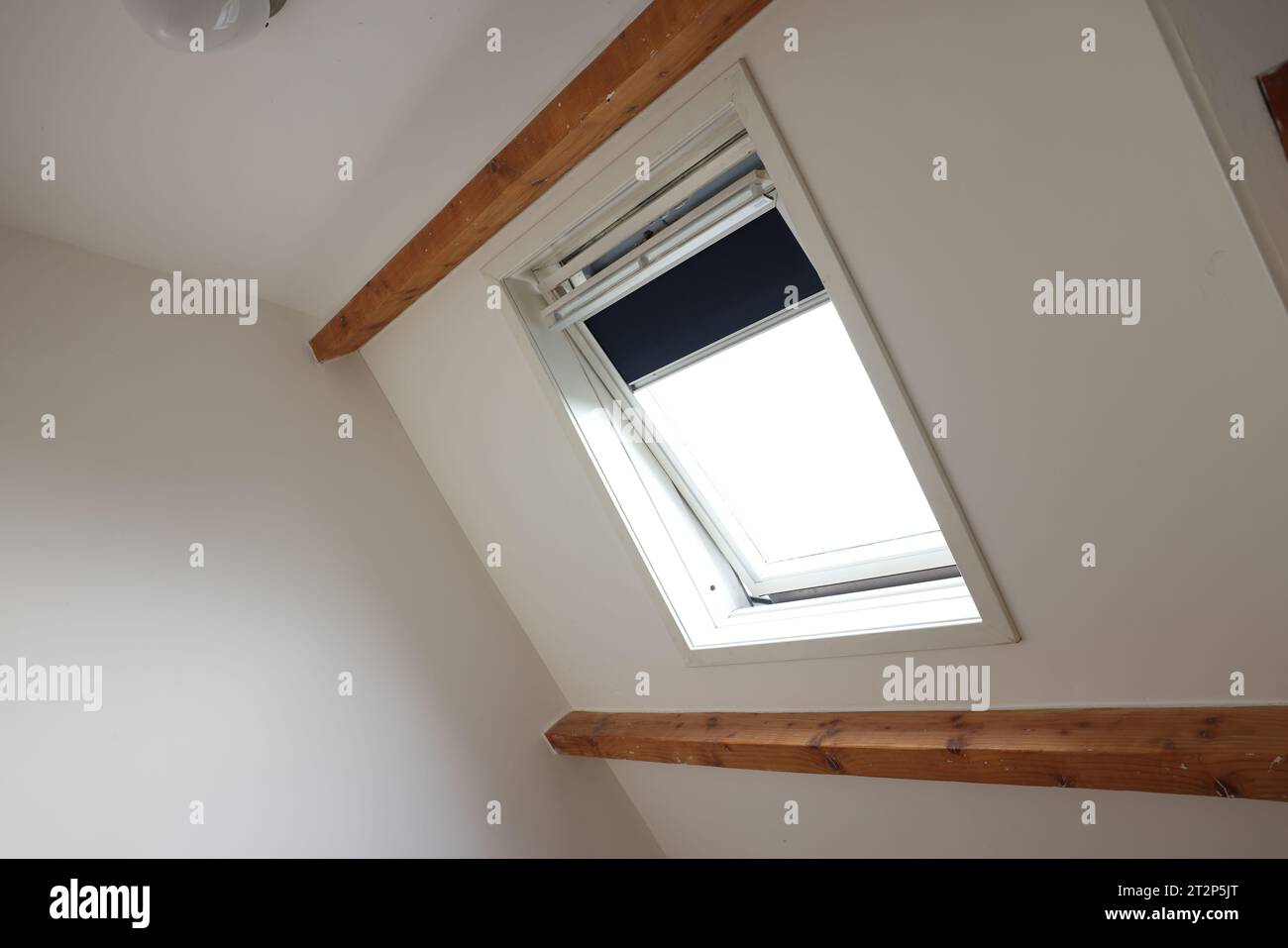 Roof window on slanted ceiling indoors, low angle view Stock Photo - Alamy