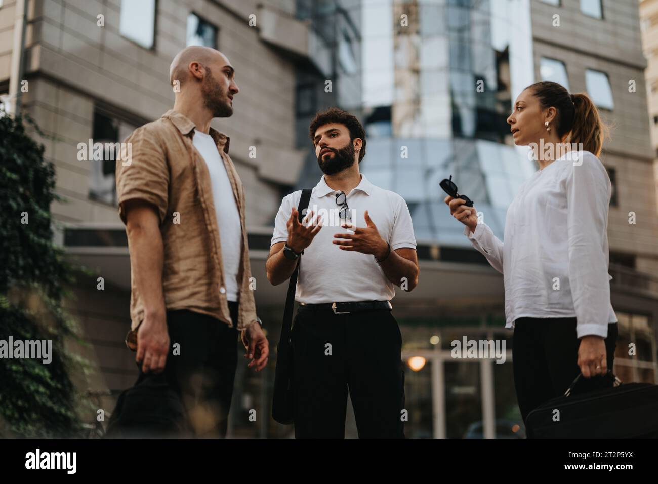 Successful Urban City Professionals Analyzing Project Details Outdoors ...