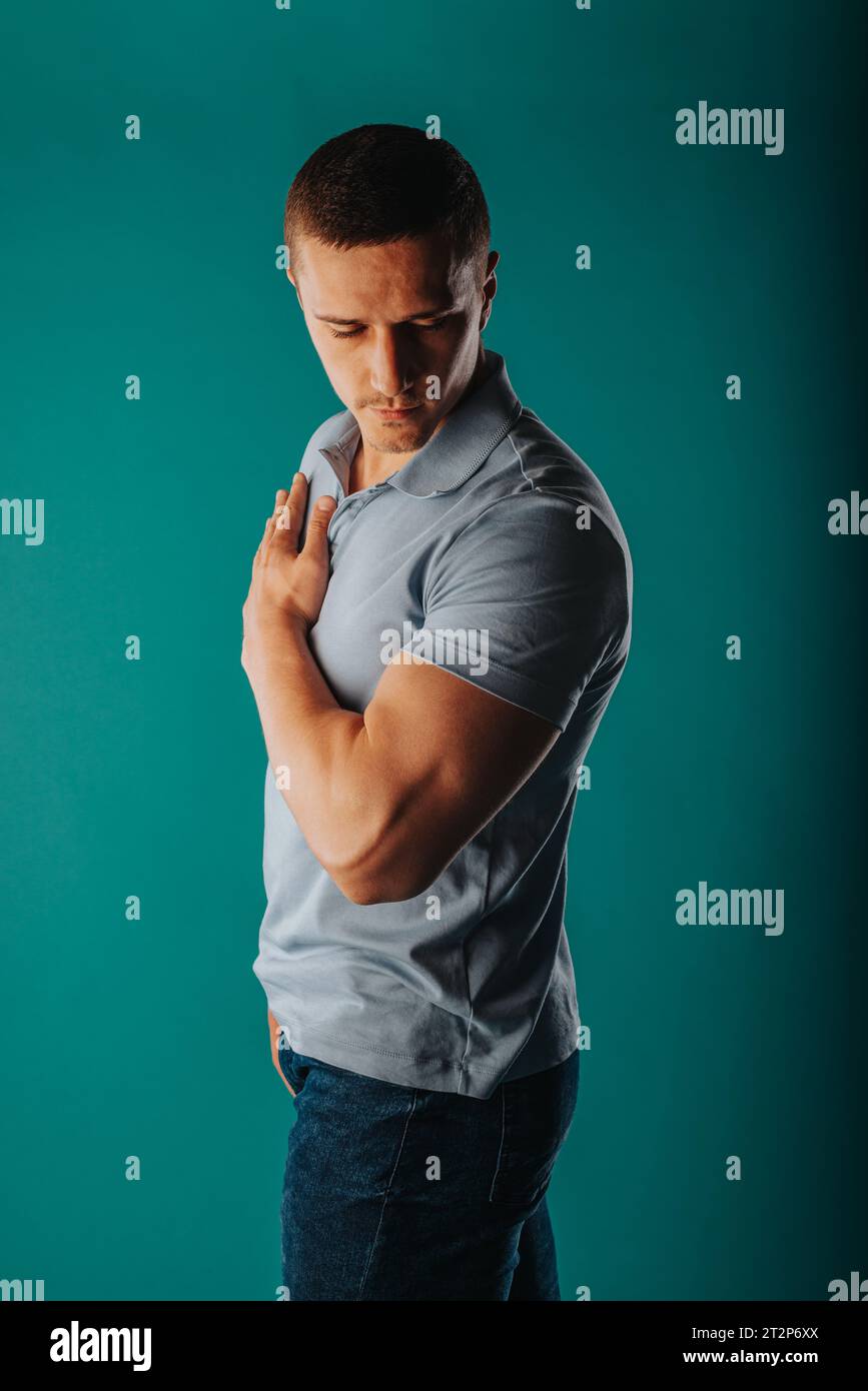 Appealing and well-built man flexing his muscles Stock Photo - Alamy