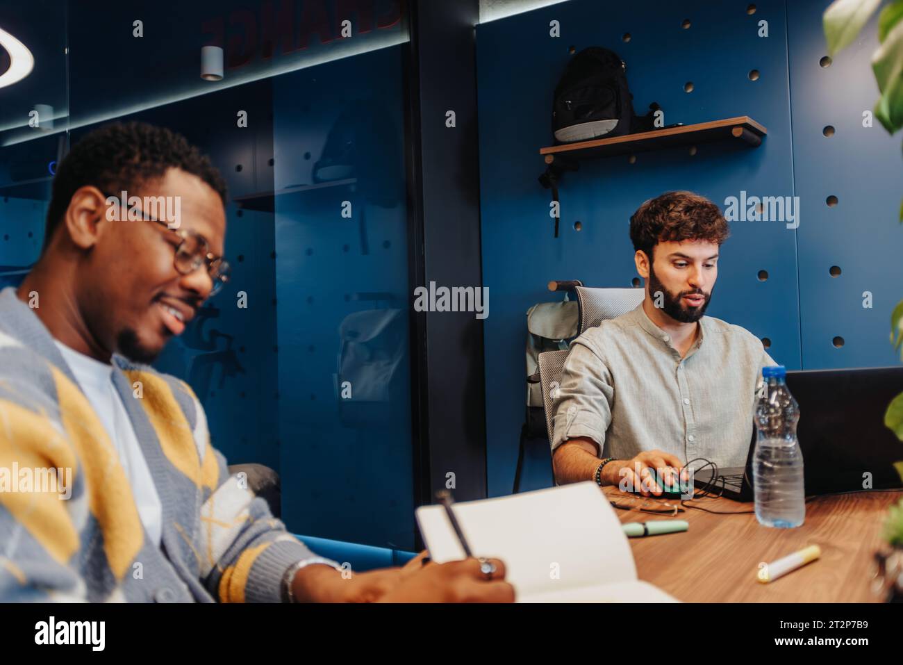 Diverse group of entrepreneurs collaborates in a modern co-working ...