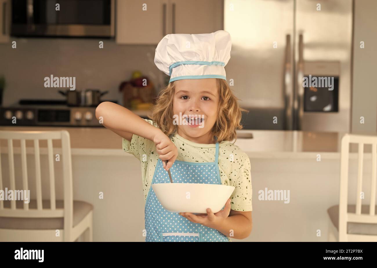 Child chef cook with cooking plate. Fun kids kitchen. Funny little kid ...