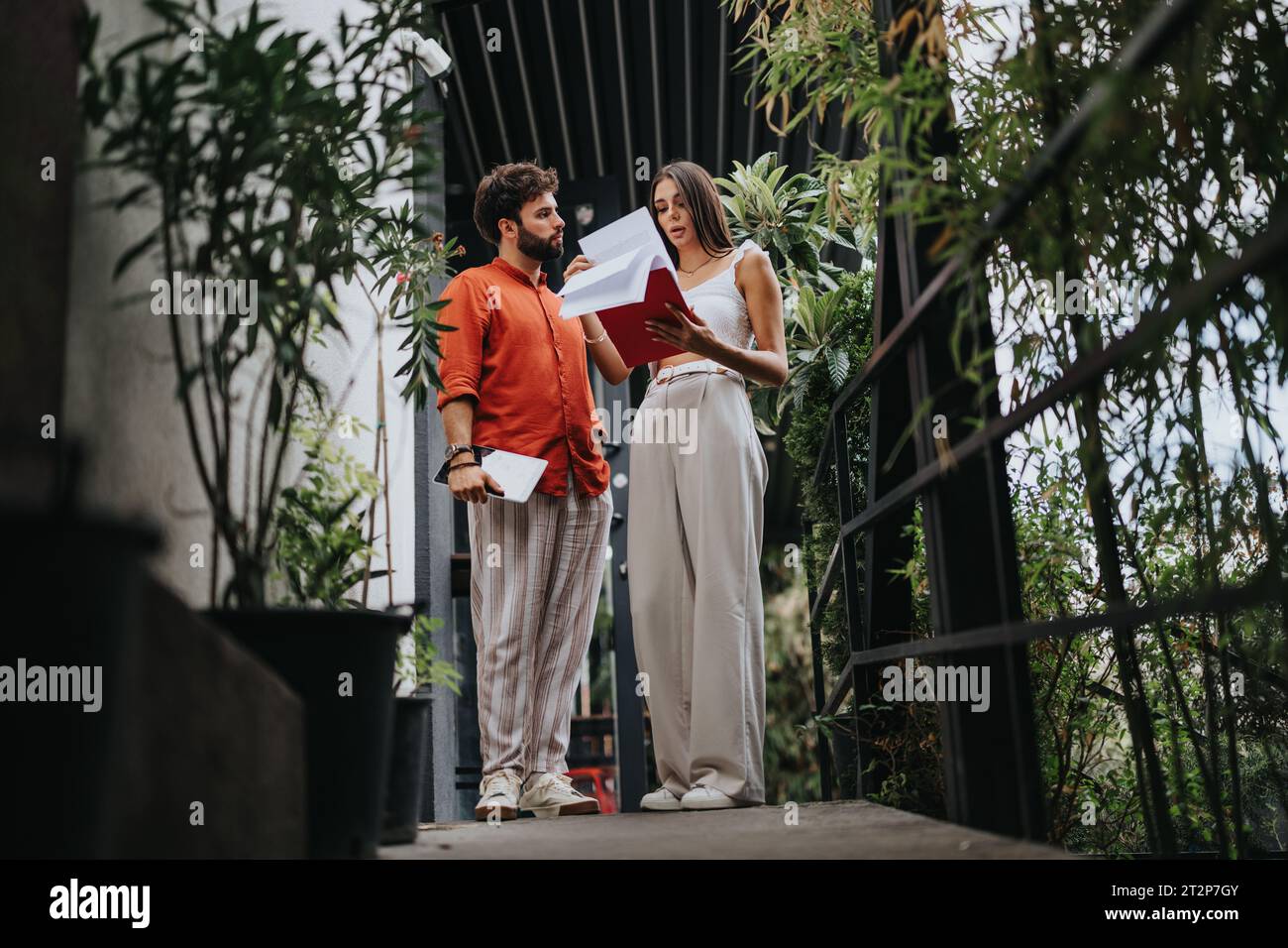 Collaborative Architects Discussing Blueprint at Construction Site ...