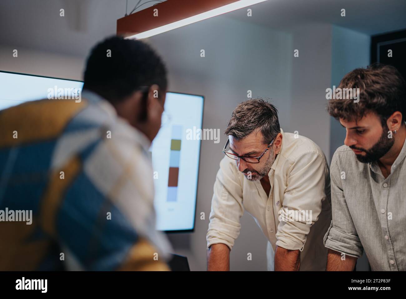 Business team in modern conference room collaborates on architectural ...