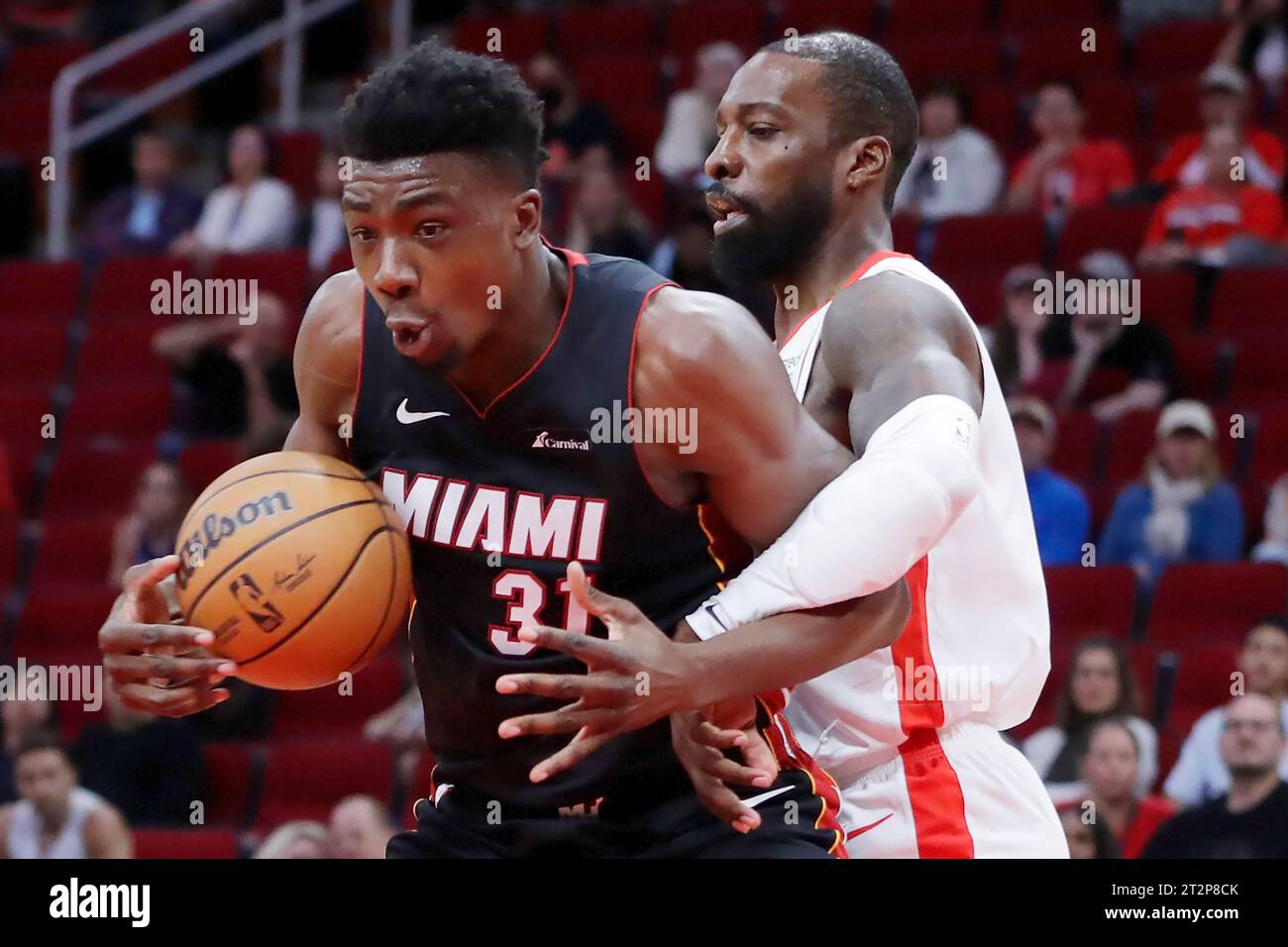 Miami Heat center Thomas Bryant, left, is fouled as he looks for a shot ...