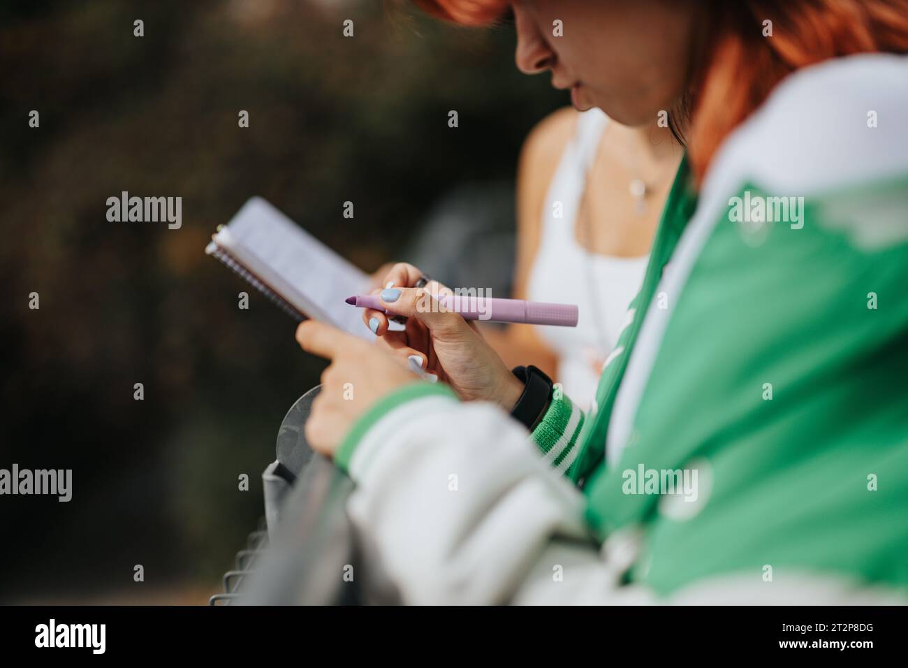 High school girls working together on a project, studying outdoors in ...