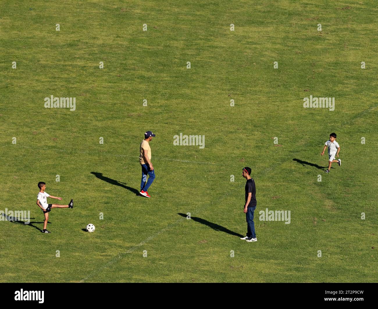 Melbourne Australia / A family playing soccer in the afternoon sunshine ...