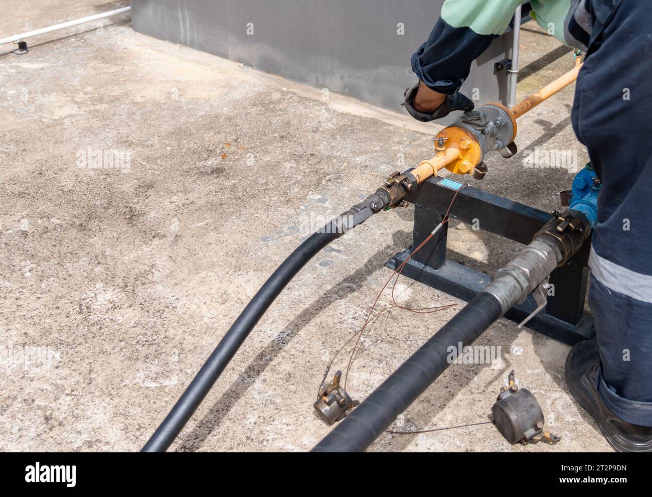 Operator connect pipe and open valve to load LPG liquid tank. LPG gas ...