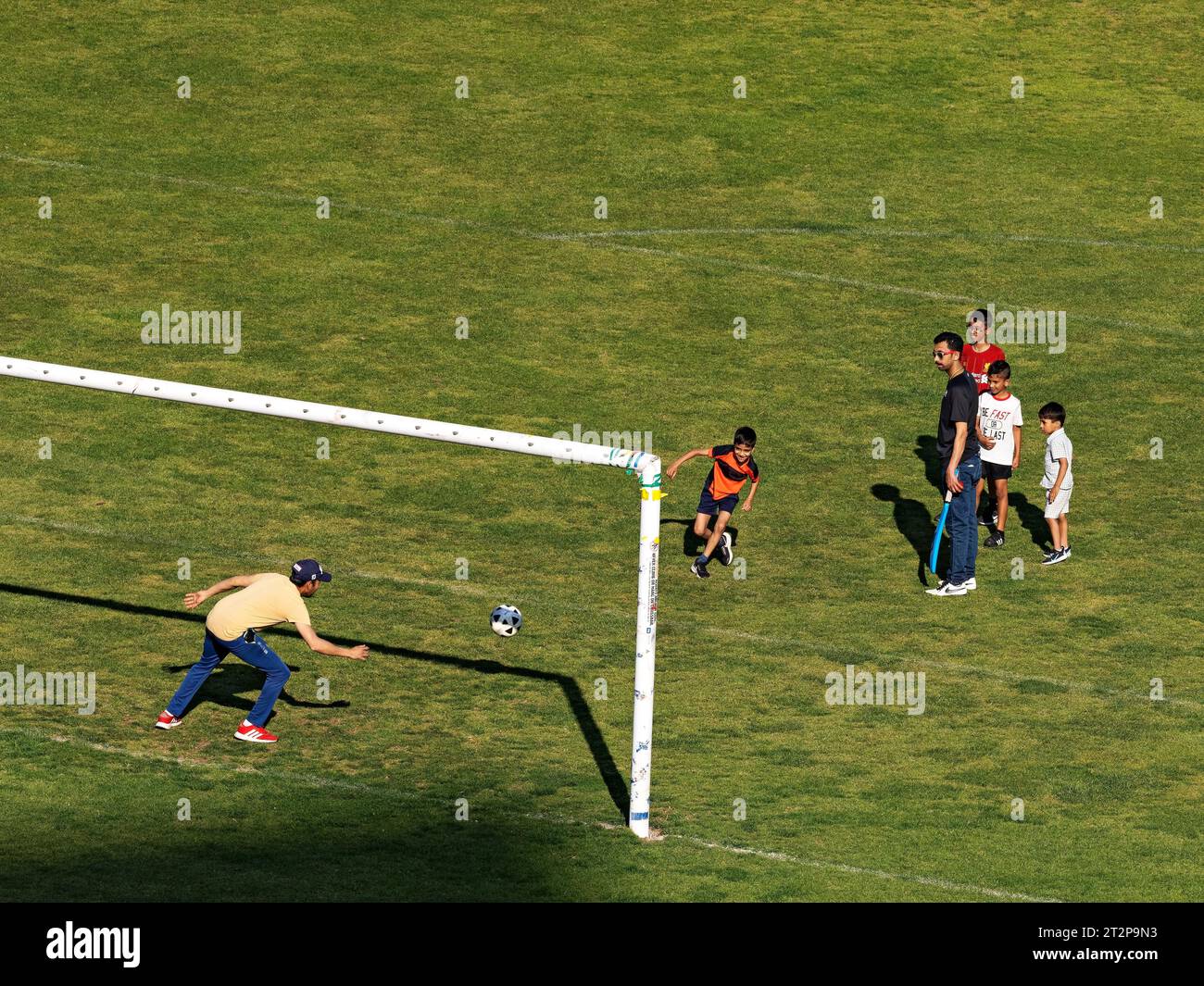 Melbourne Australia / A family playing soccer in the afternoon sunshine ...
