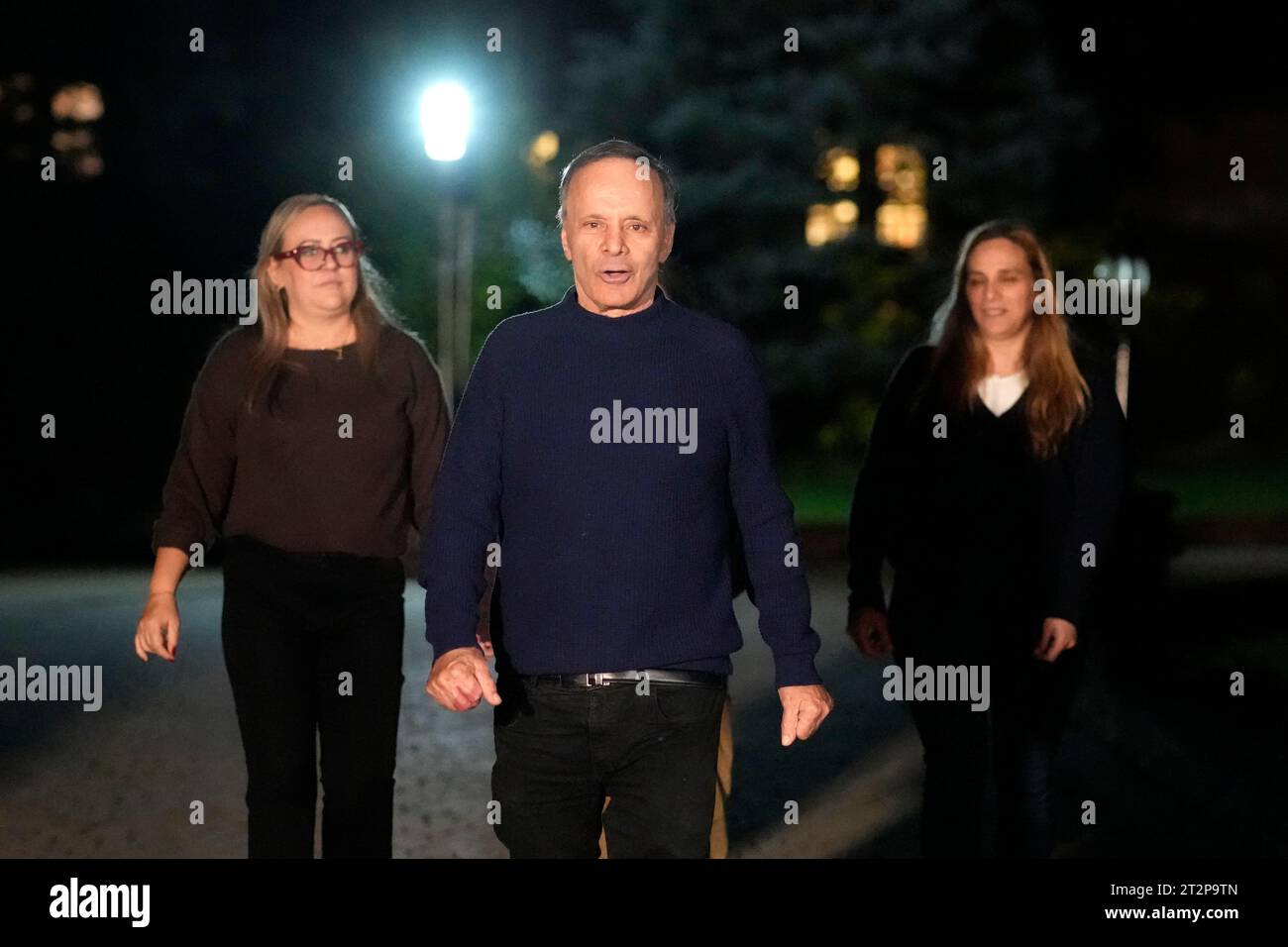 Uri Raanan walks down the driveway of his Bannockburn, Ill., home with ...