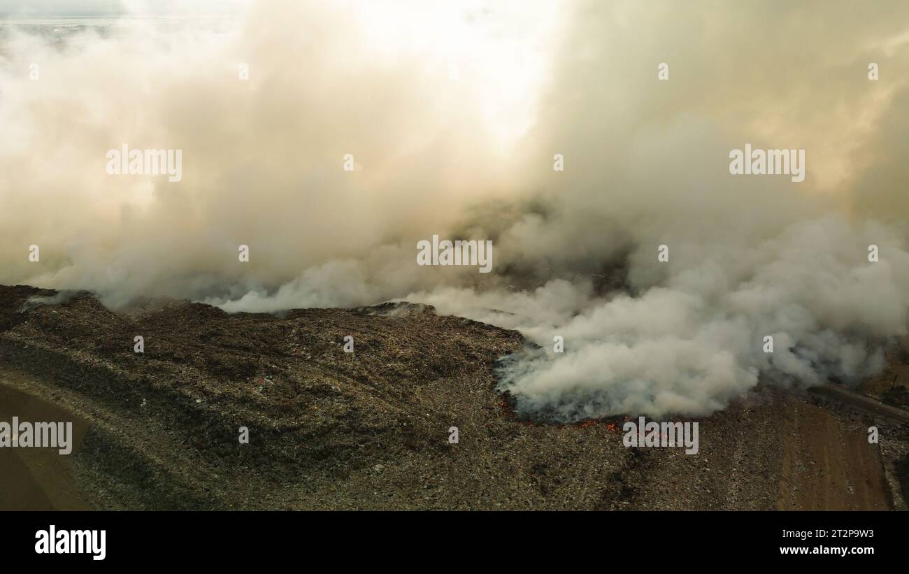 Aerial view of a catastrophic fire at a large landfill, plastic waste ...