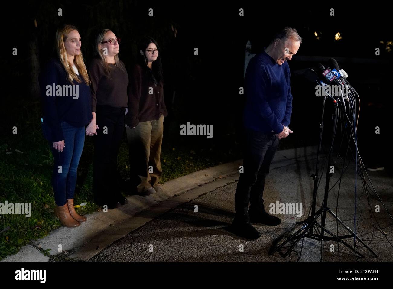 Uri Raanan, right, pauses as he talks to reporters outside his ...
