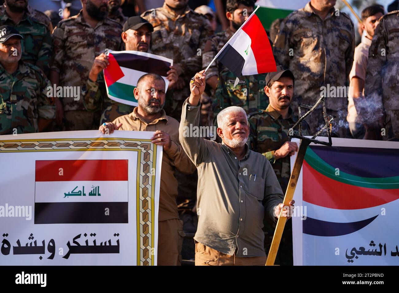Mosul, Iraq. 20th Oct, 2023. A man holds the Star of David burning as ...