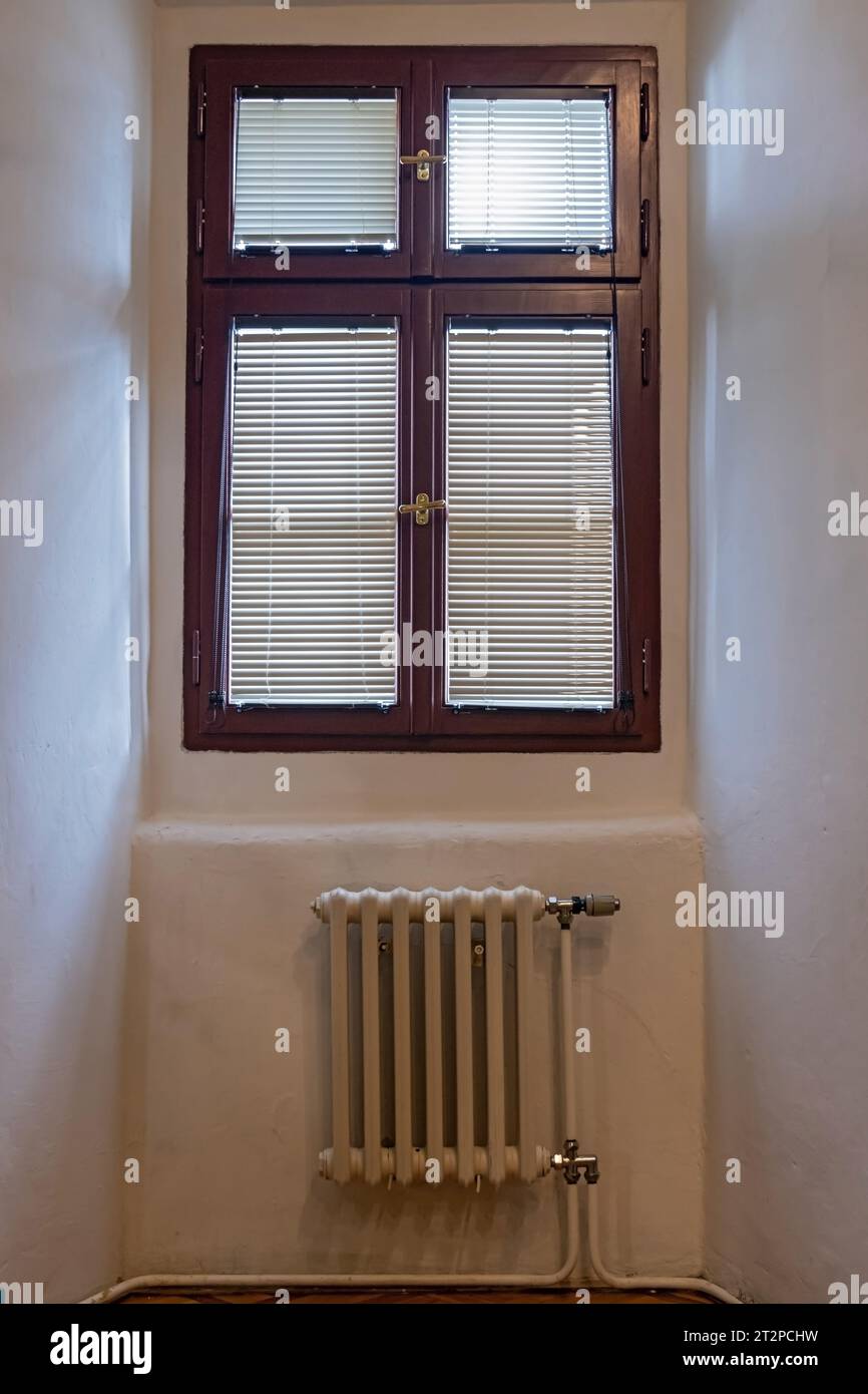 Windows with horizontal blinds in a room with a heating radiator Stock ...