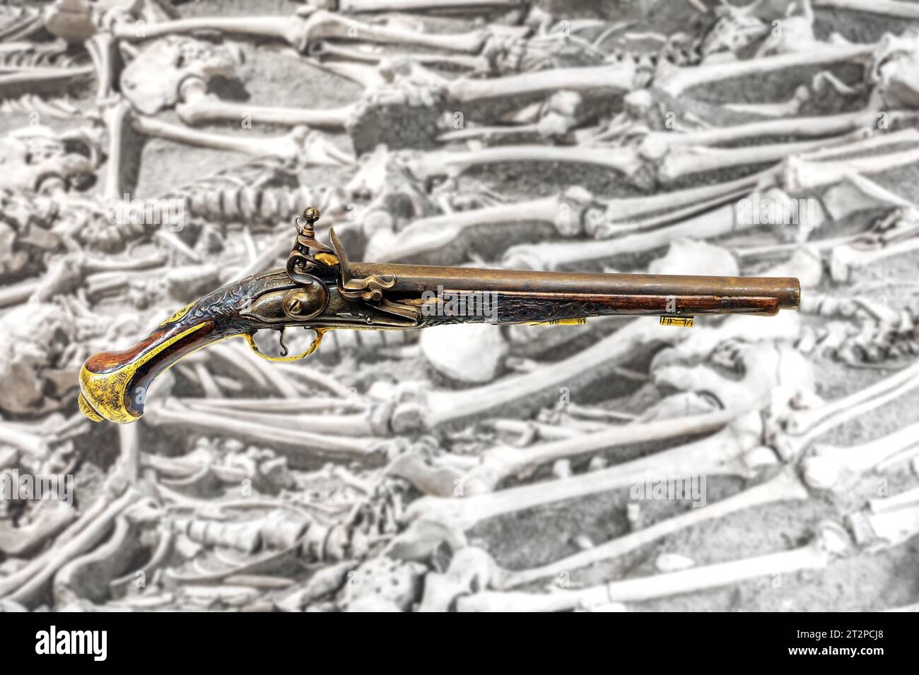 Historic flintlock pistol, on a blurred background skeletons of the ...
