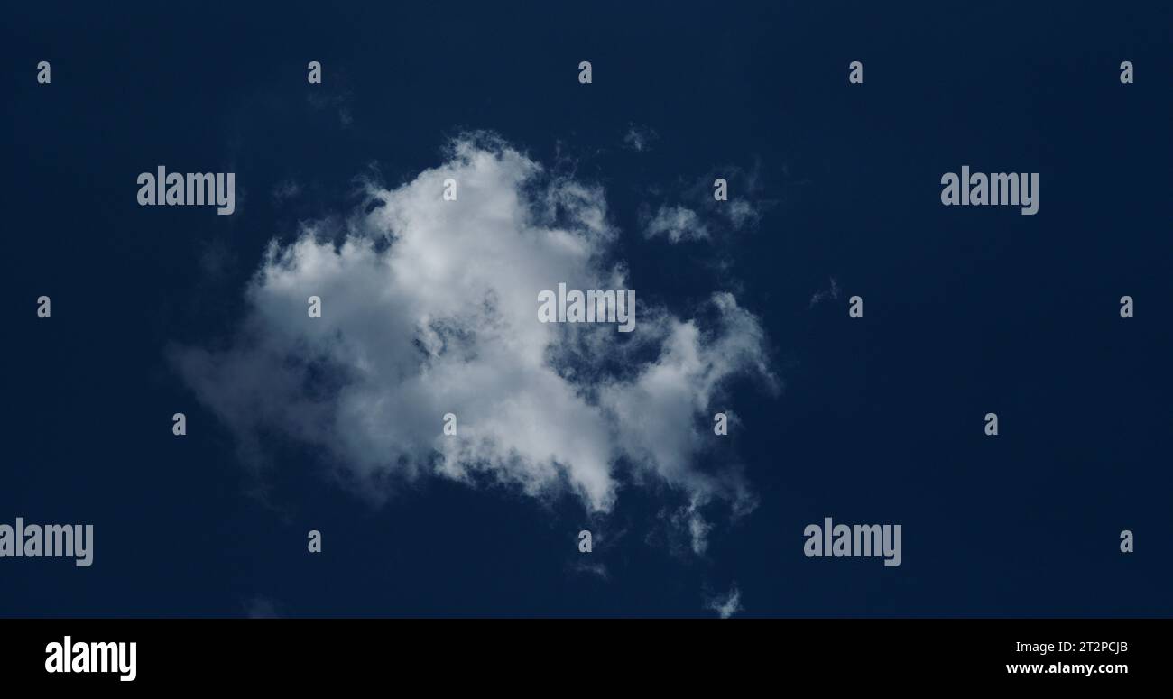 Cumulus humilis clouds emerge from the shadow of a neighboring cloud ...