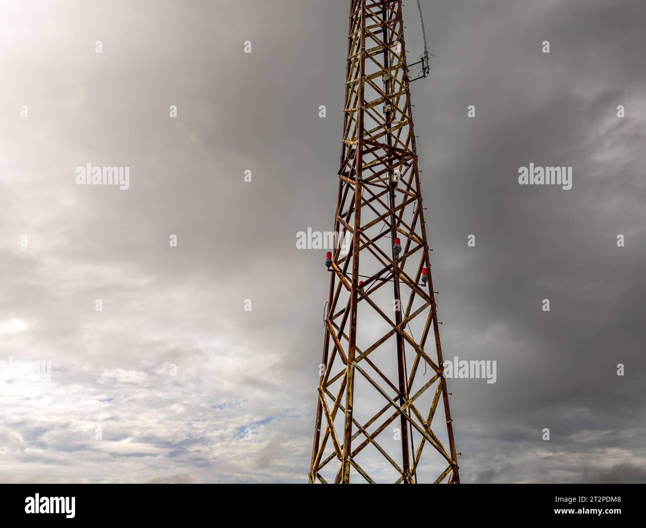 Old television and radio tower in faded colors with rusty structural ...