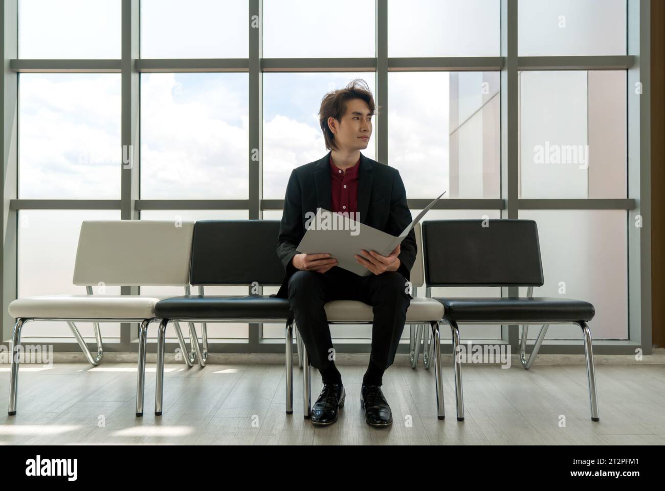 Professional businessman sitting on a sleek chair in a modern office ...
