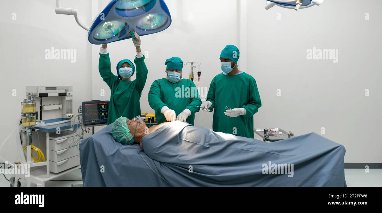 Group of surgeons, steeped in concentration, performing complex surgery ...