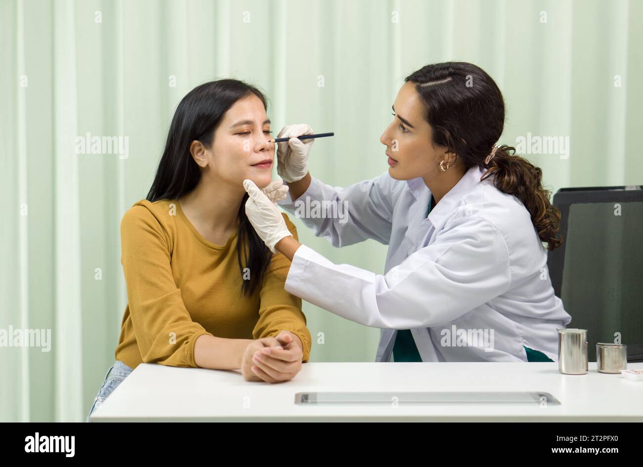 A professional healthcare provider is precisely performing a nose ...