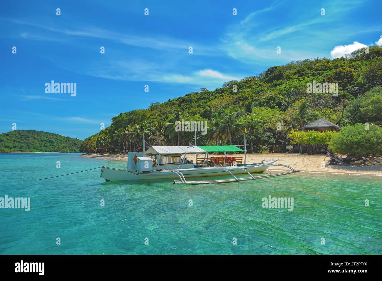 A wooden boat on the beach of the island in Coron Bay. Busuanga ...