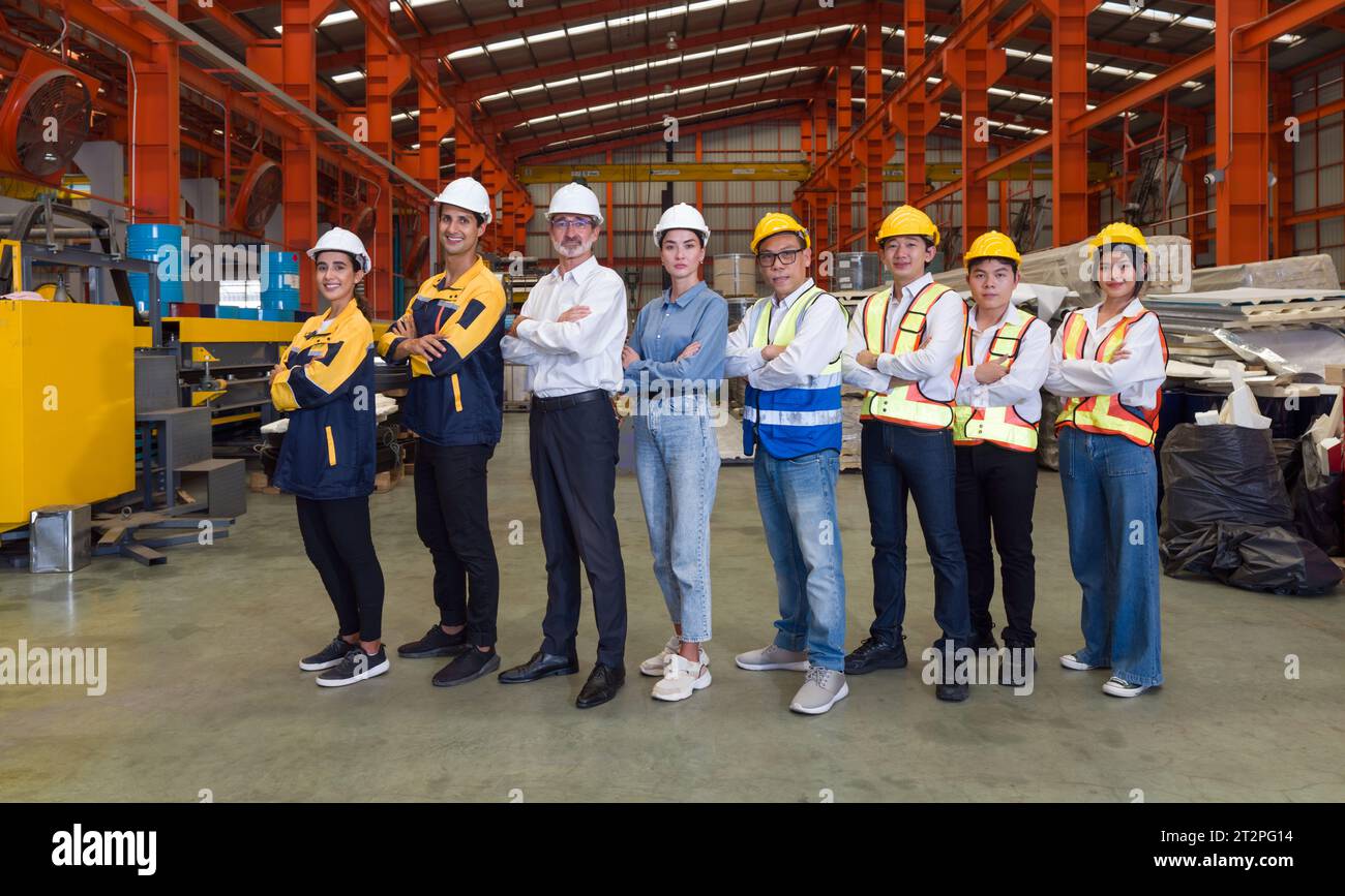 Industrial teamwork. Group of male and female factory labor stand ...
