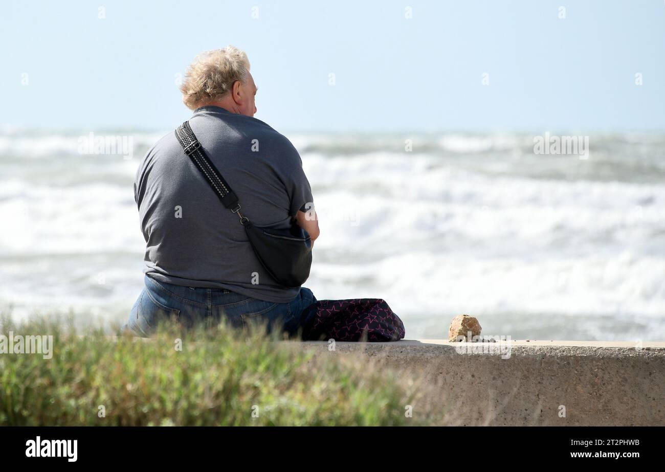 Images of bad weather on the beach of Palma in Mallorca. Tourists walk ...
