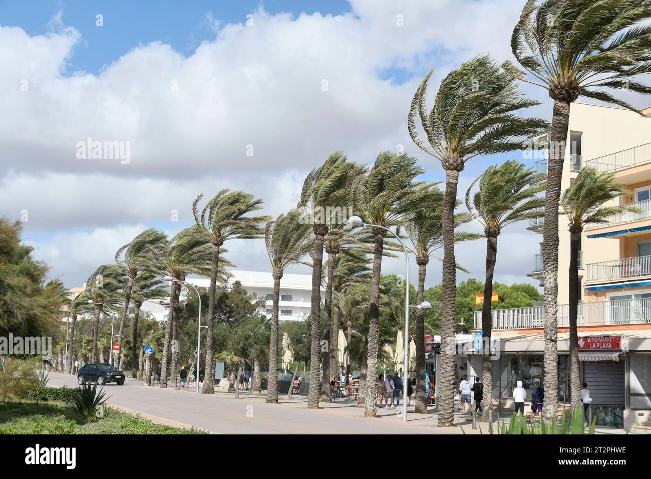 Images of bad weather on the beach of Palma in Mallorca. Tourists walk ...