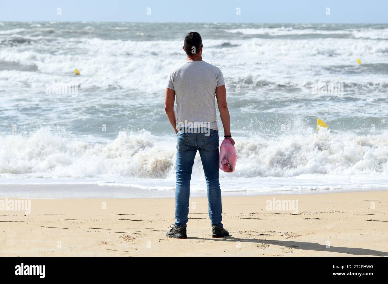 Images of bad weather on the beach of Palma in Mallorca. Tourists walk ...
