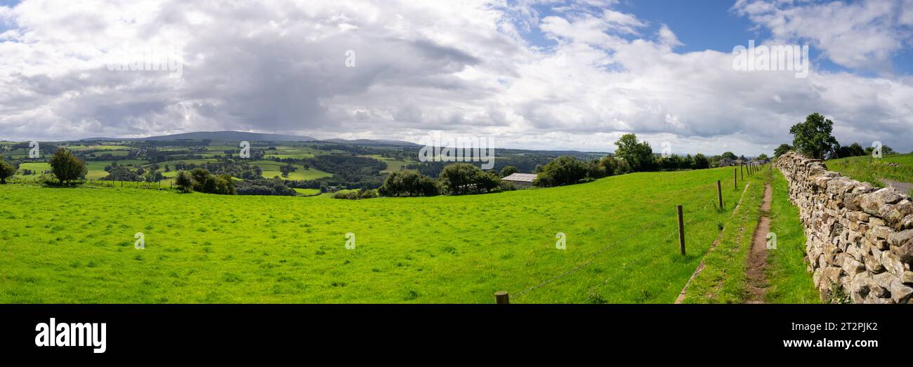a panoramic view looking across pastures and farms on hill and dale in ...