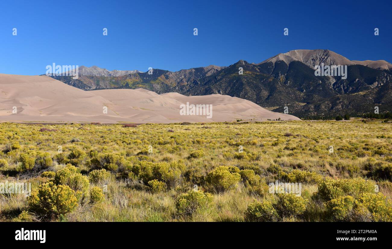 sand dunes and peaks of the sangre de cristo mountains on a sunny day ...