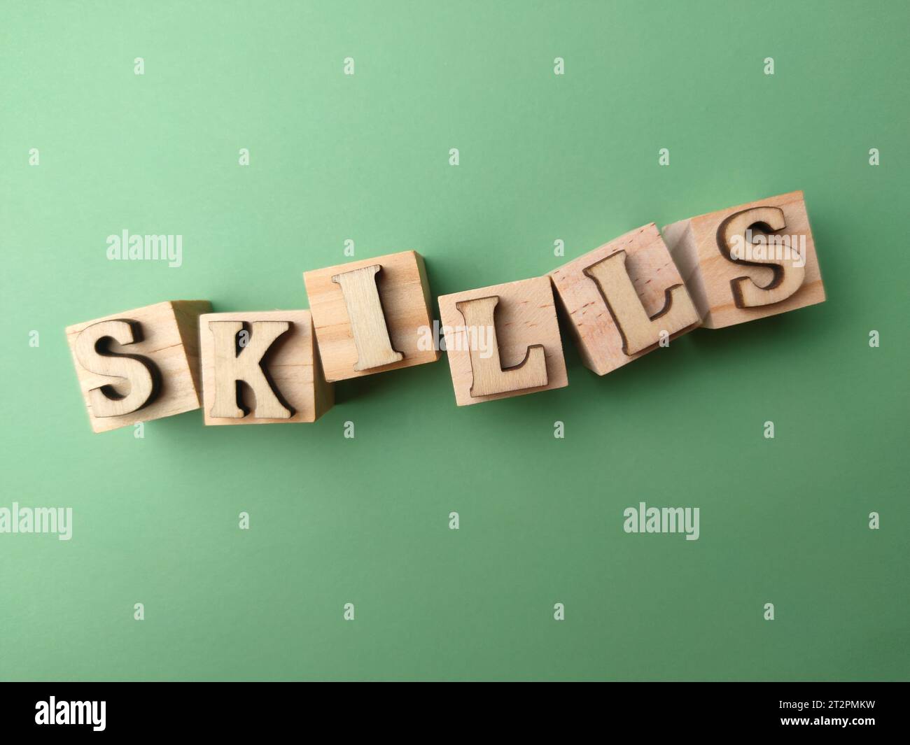 Top view wooden block and word with word SKILLS on green background ...