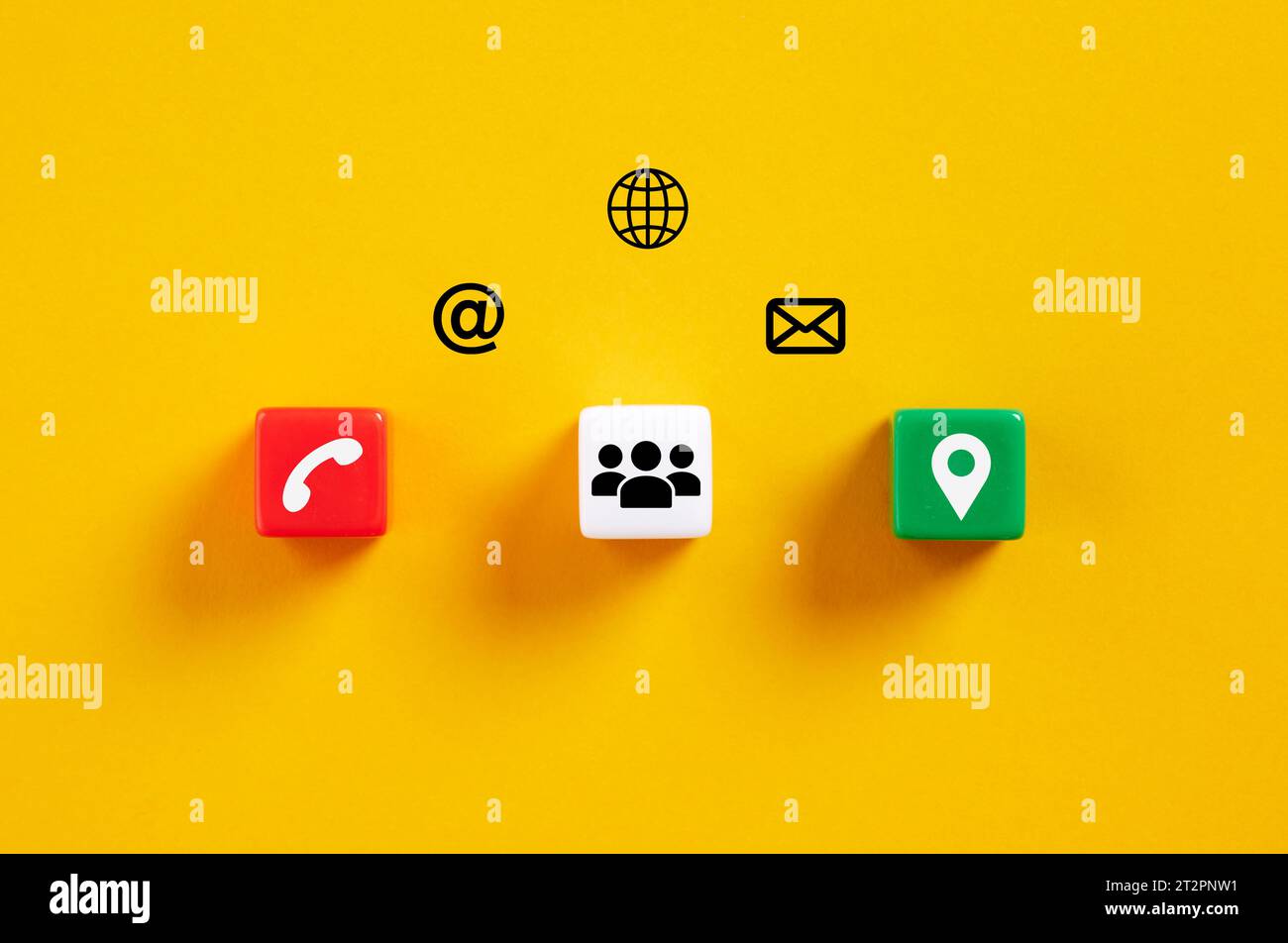 Contact and communication symbols on colorful cubes on yellow ...