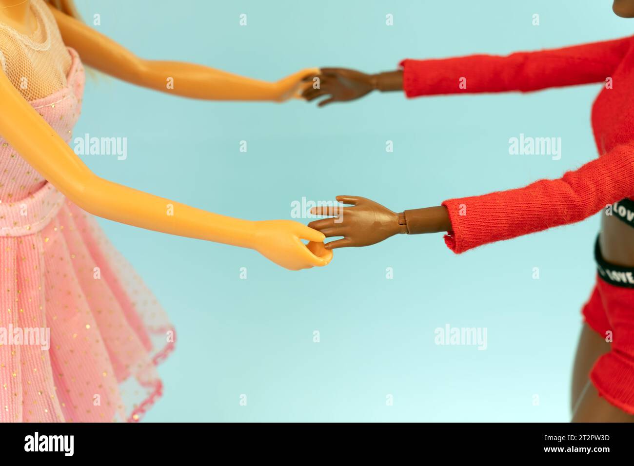 two plastic dolls holding each other's hand. concept of friendship ...