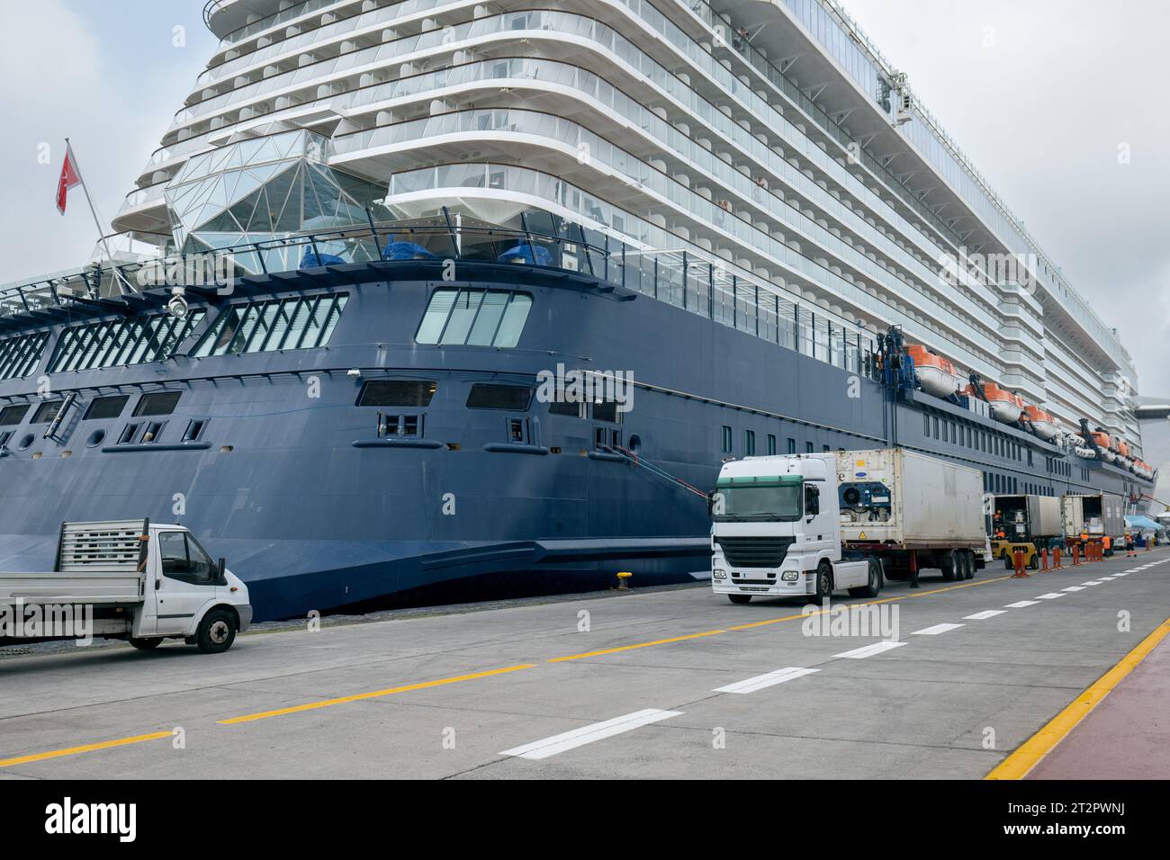 cruise ship in port with delivery trucks in foreground Stock Photo - Alamy