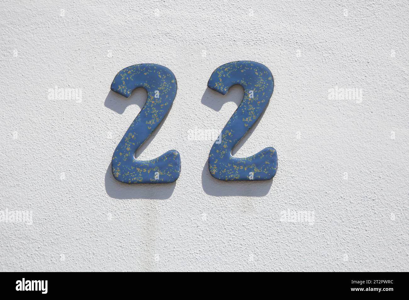 House number 22. Painted iron over whitewashed wall. Houses with ...