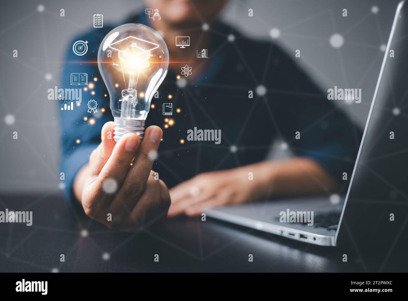 Hand holding light bulb showing graduation cap internet education ...