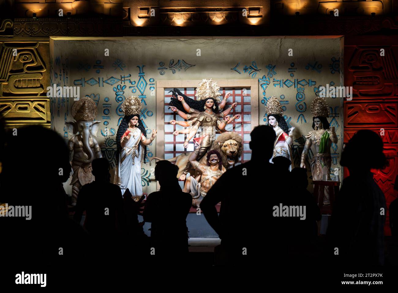 Devotees looks at the idol of Goddess Durga at a Maya civilization ...