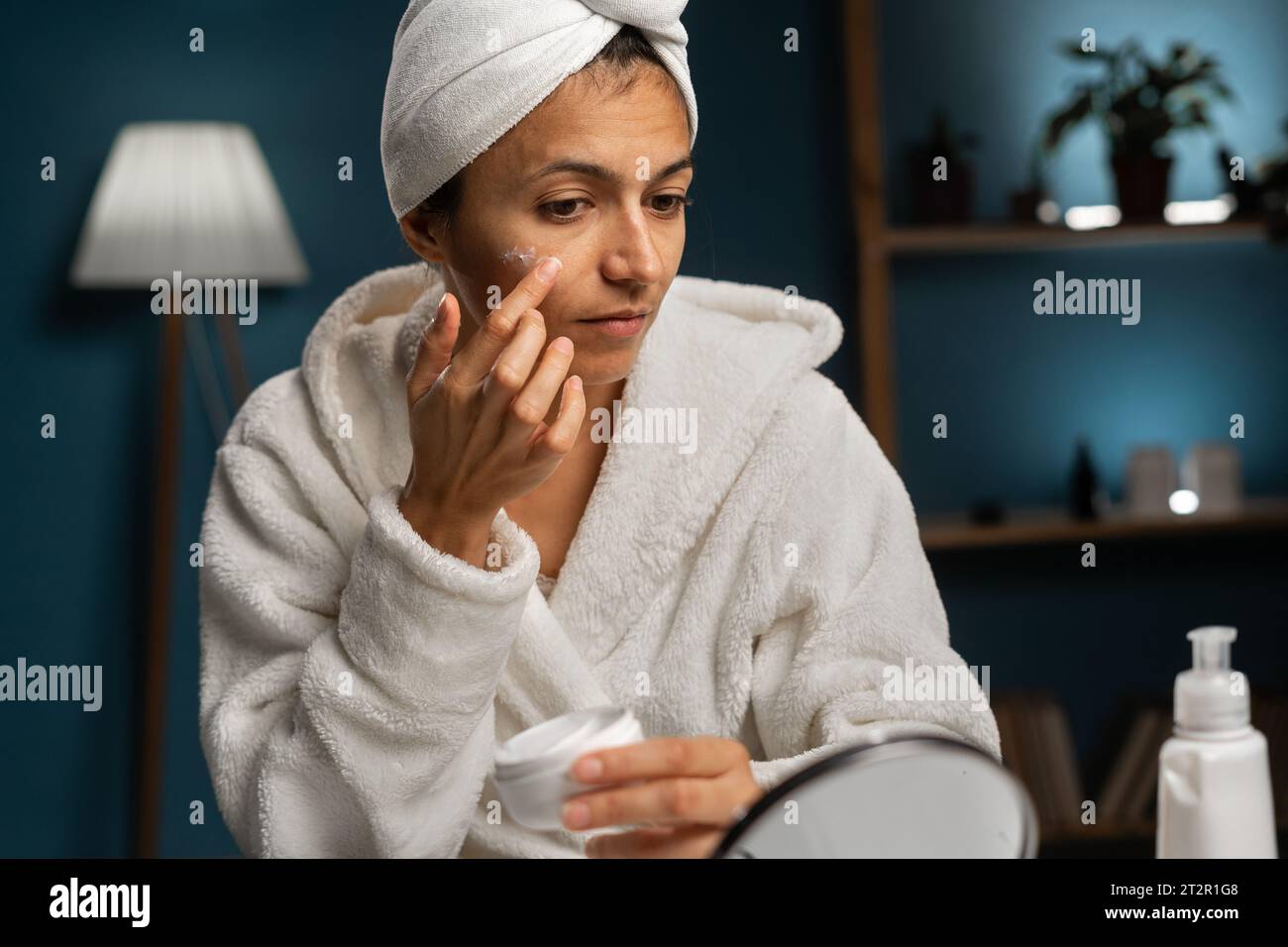 Hispanic Woman Apply Facial Cream Look In Small Mirror Healthy Lady