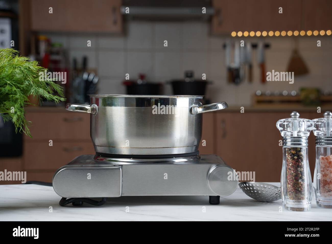 Steel cooking pan without lid on electric hob with boiling water Stock ...