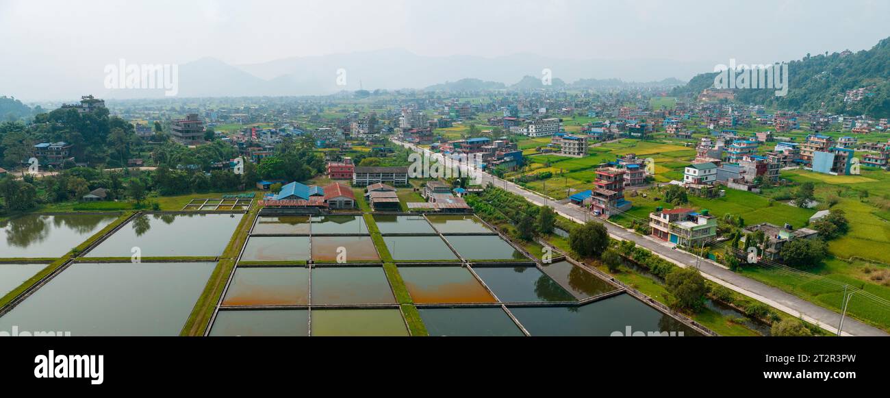 Aerial view of a nepalese rural landscape near Lake Bagnes, rice fields ...