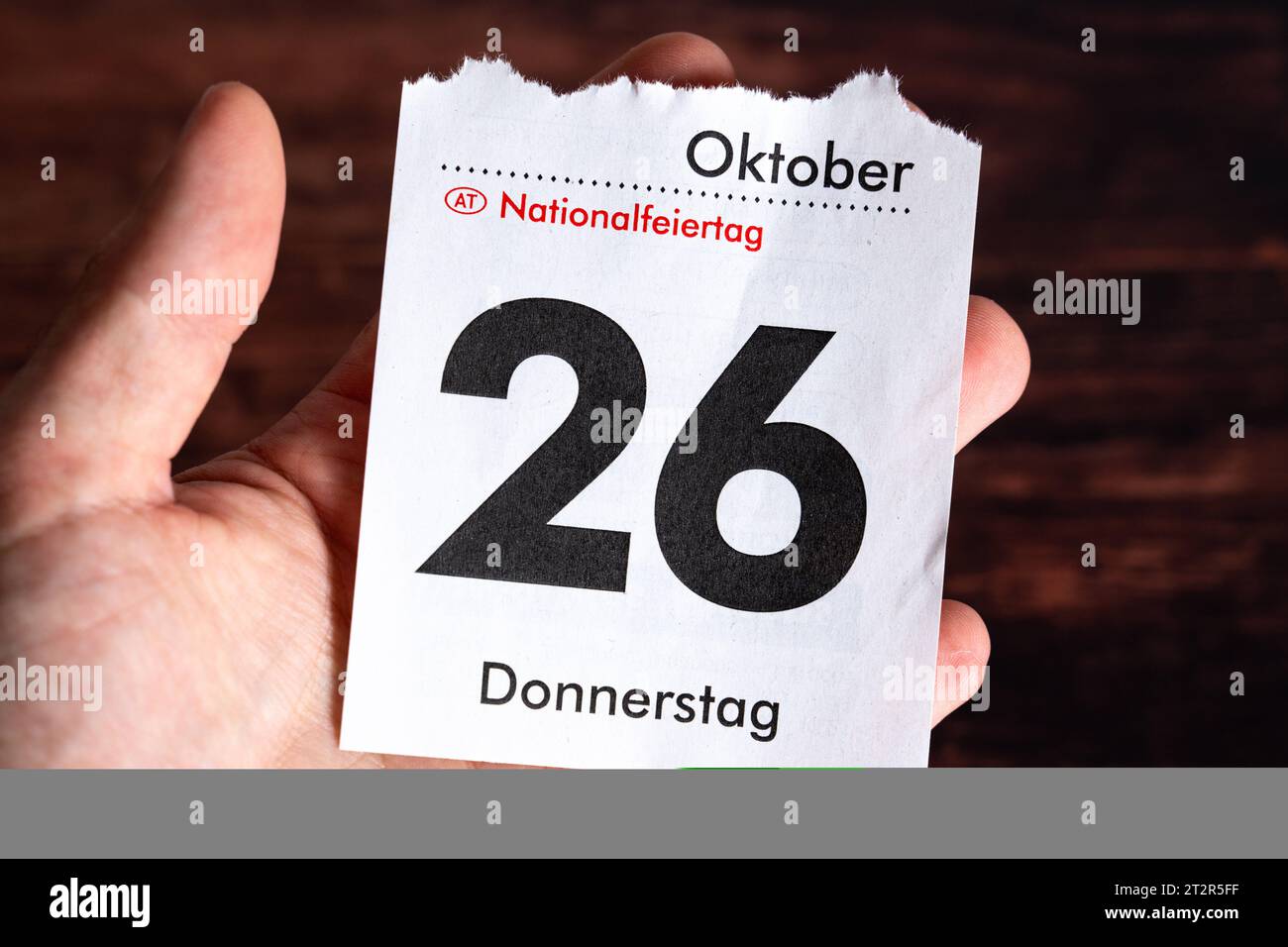 Hand holding calendar page with October 26, national holiday in ...