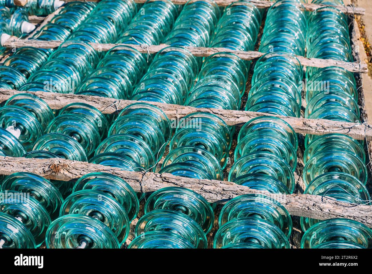 Glass transparent high-voltage insulator is in storage. Industrial ...