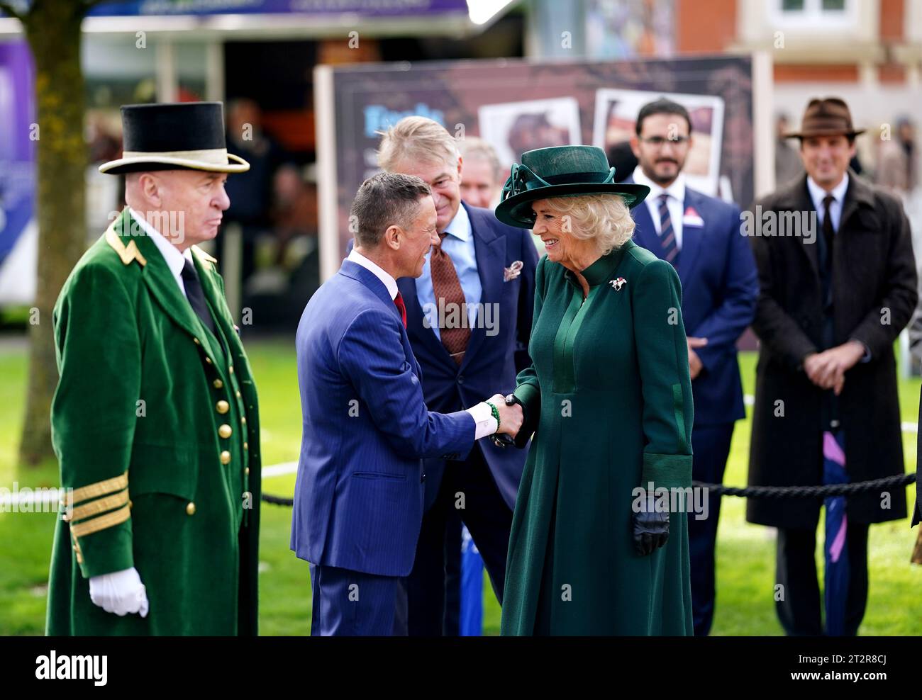Queen Camilla greets jockey Frankie Dettori during a ceremony to unveil ...