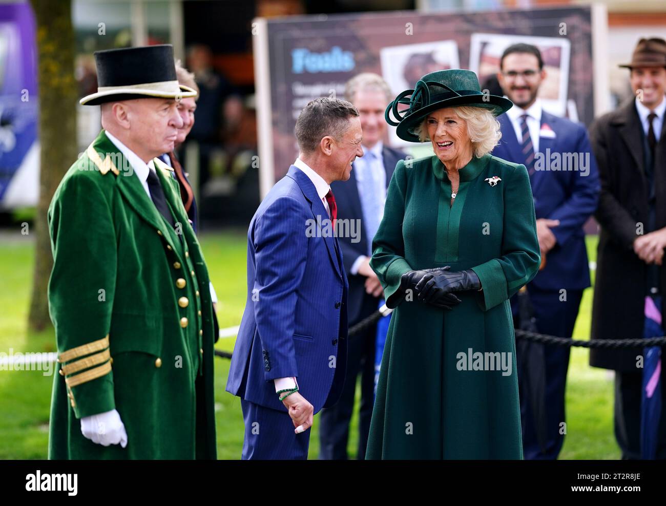 Queen Camilla speaks to jockey Frankie Dettori during a ceremony to ...