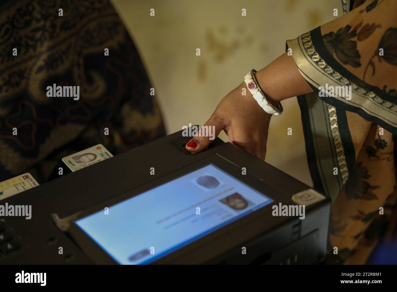 A woman casts her vote during Dhaka City Corporation polls using ...