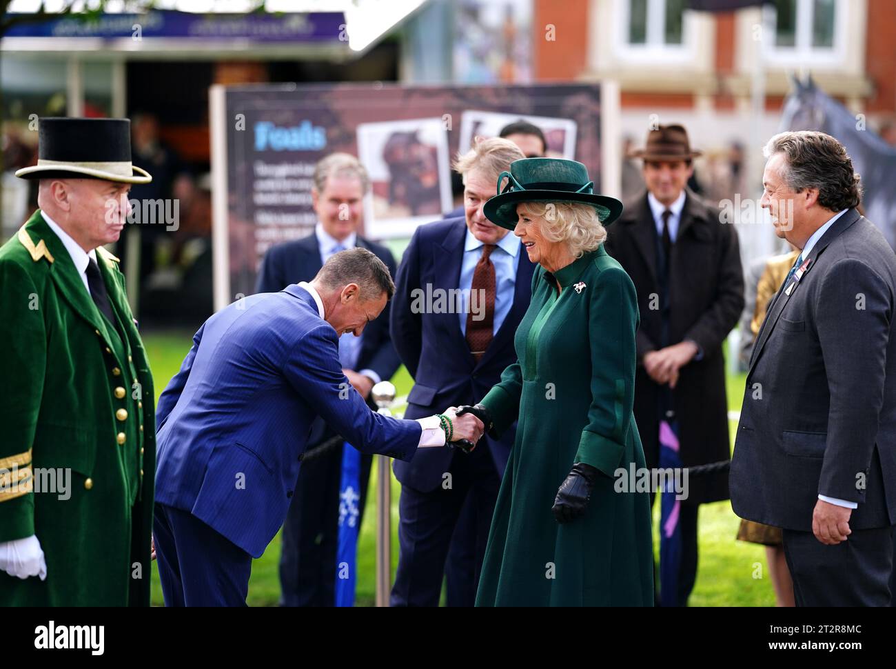 Queen Camilla greets jockey Frankie Dettori during a ceremony to unveil ...
