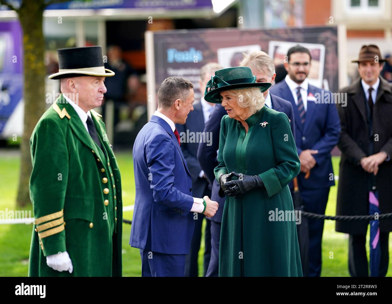 Queen Camilla speaks to jockey Frankie Dettori during a ceremony to ...