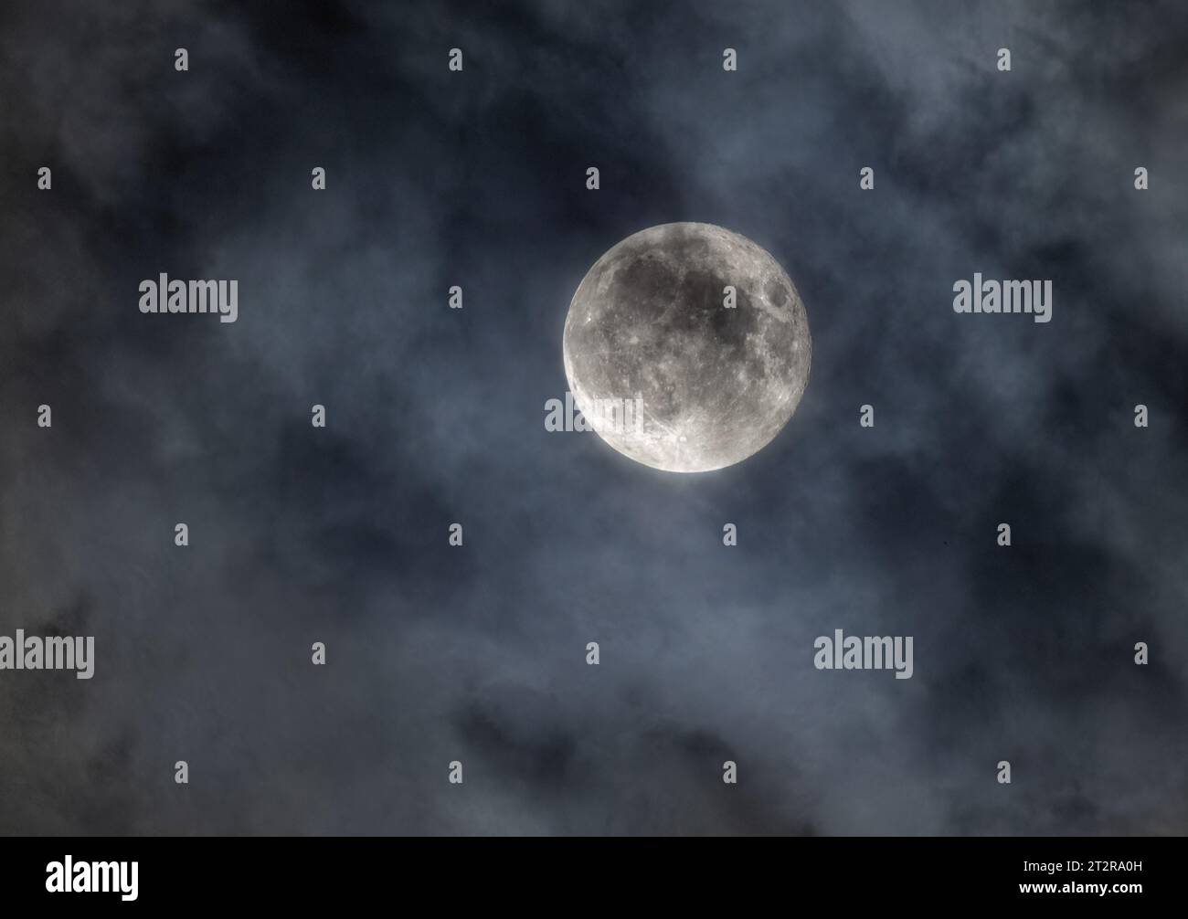 A full moon glowing among the clouds in the night sky over Canada Stock ...