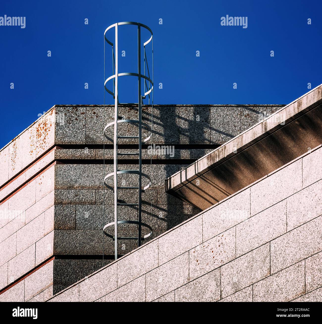 Low perspective view of an outdoor fire escape ladder on commercial ...