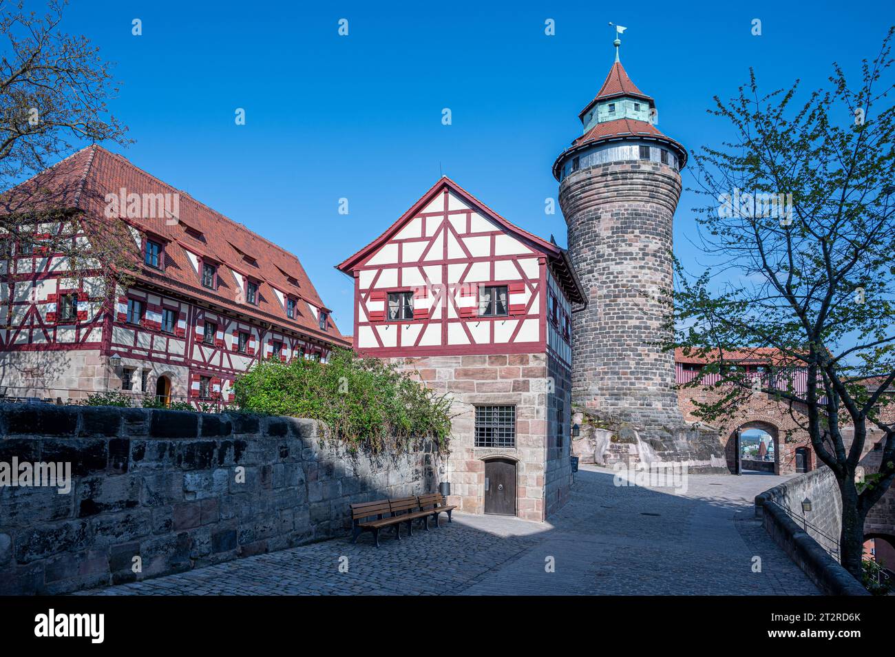 Yard of Castle of Nuremberg with half-timbered houses and tower in ...